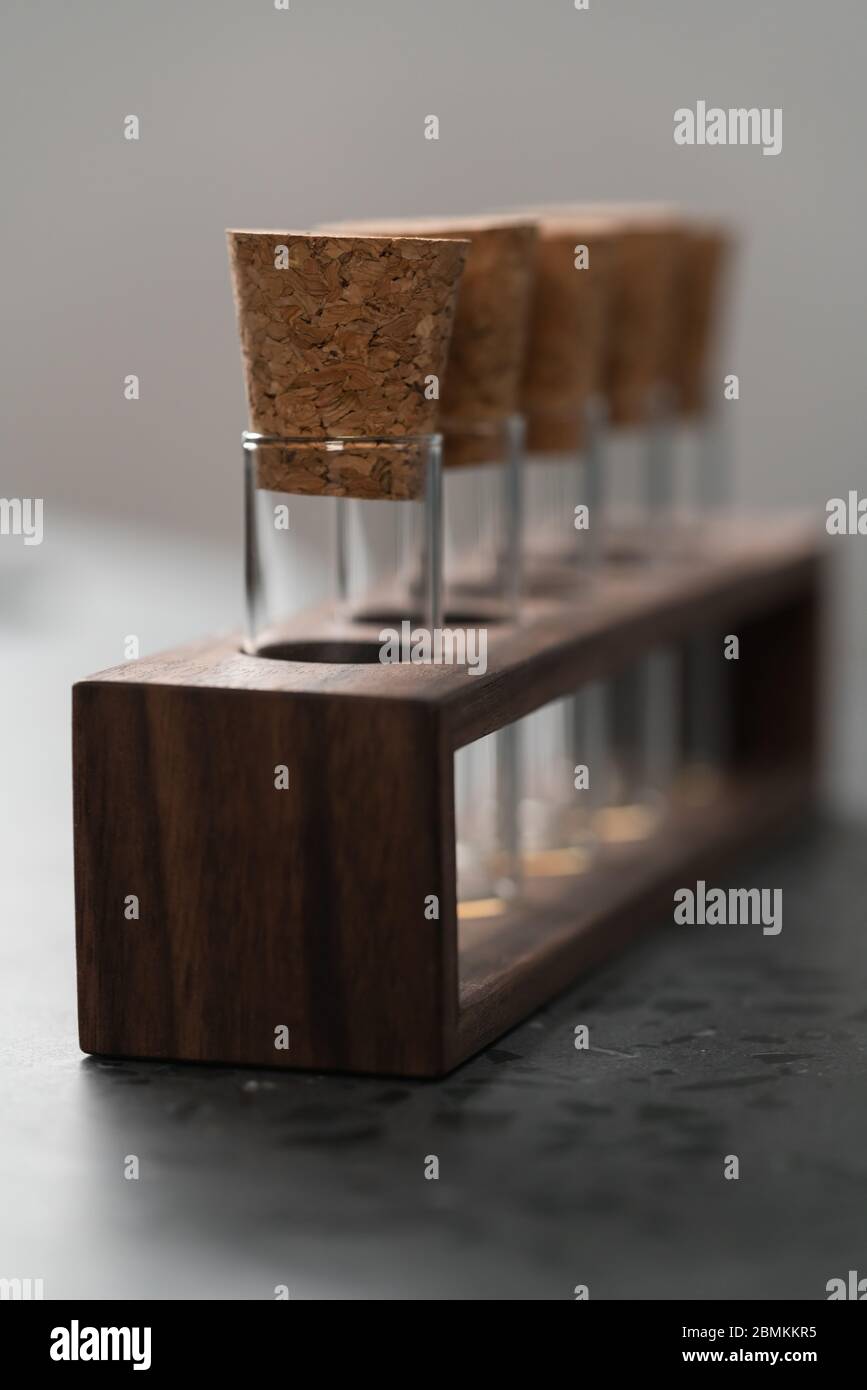empty walnut holder with glass tubes for spices on concrete surface ...