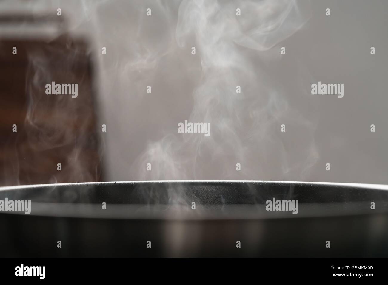 steam rising from fry pan while cooking food closeup Stock Photo - Alamy