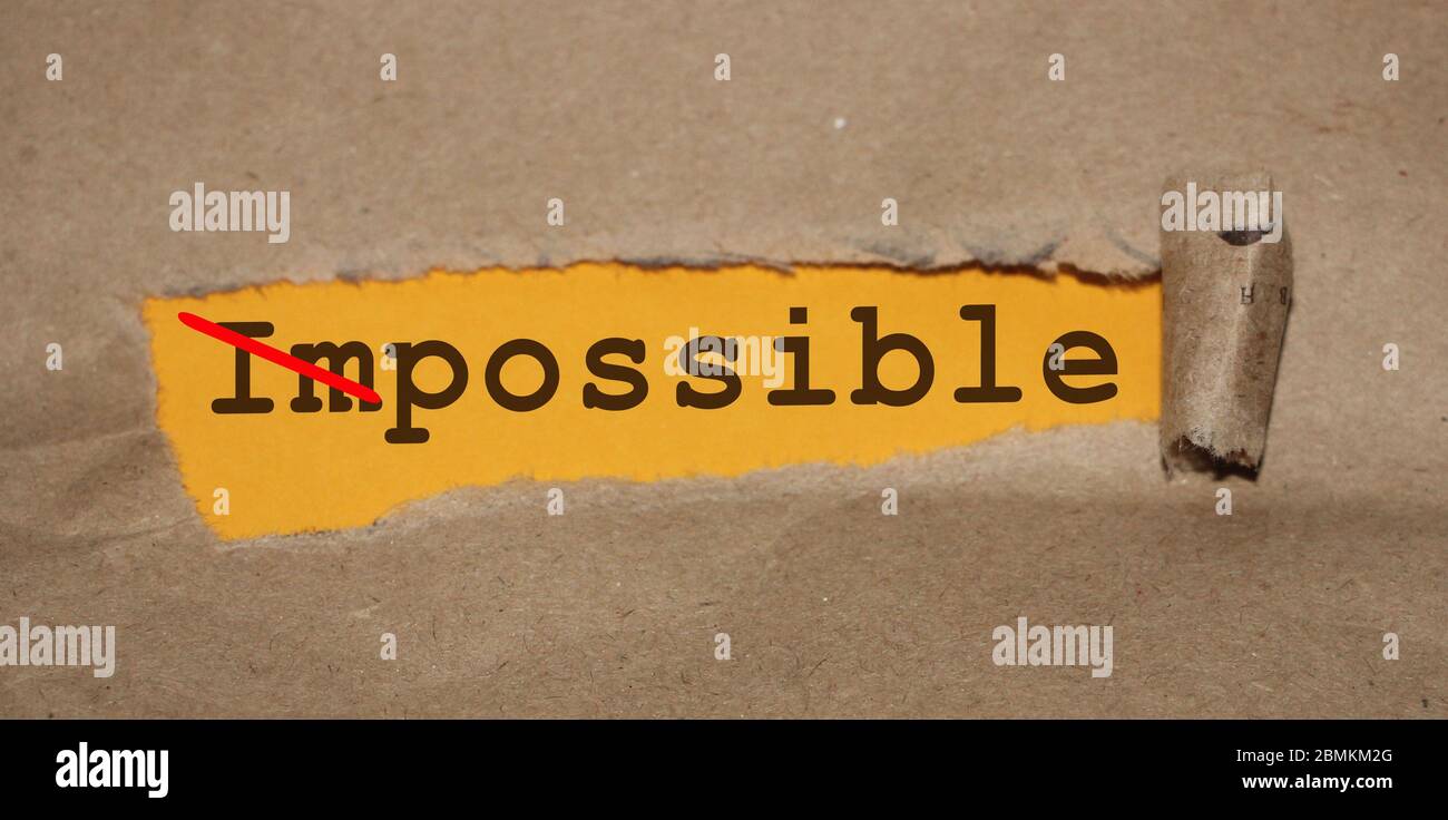 torn paper with IMPOSSIBLE word turned to Possible by crossing IM ...