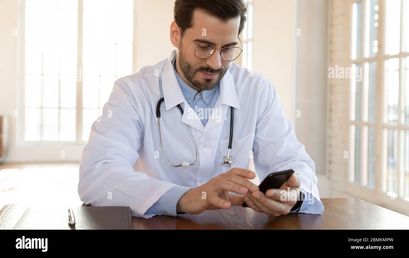 Caucasian male doctor using smartphone hi-res stock photography and ...