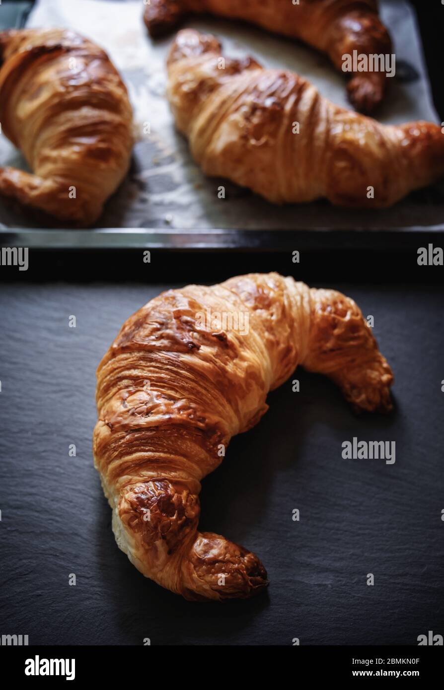 Fresh baked Croissants on black stone plate, and black tray Stock Photo ...