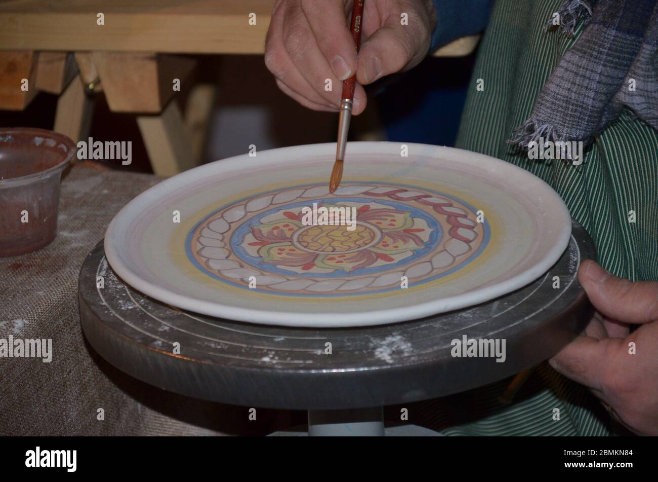 Traditional painting of a dish, handmade pottery Stock Photo - Alamy