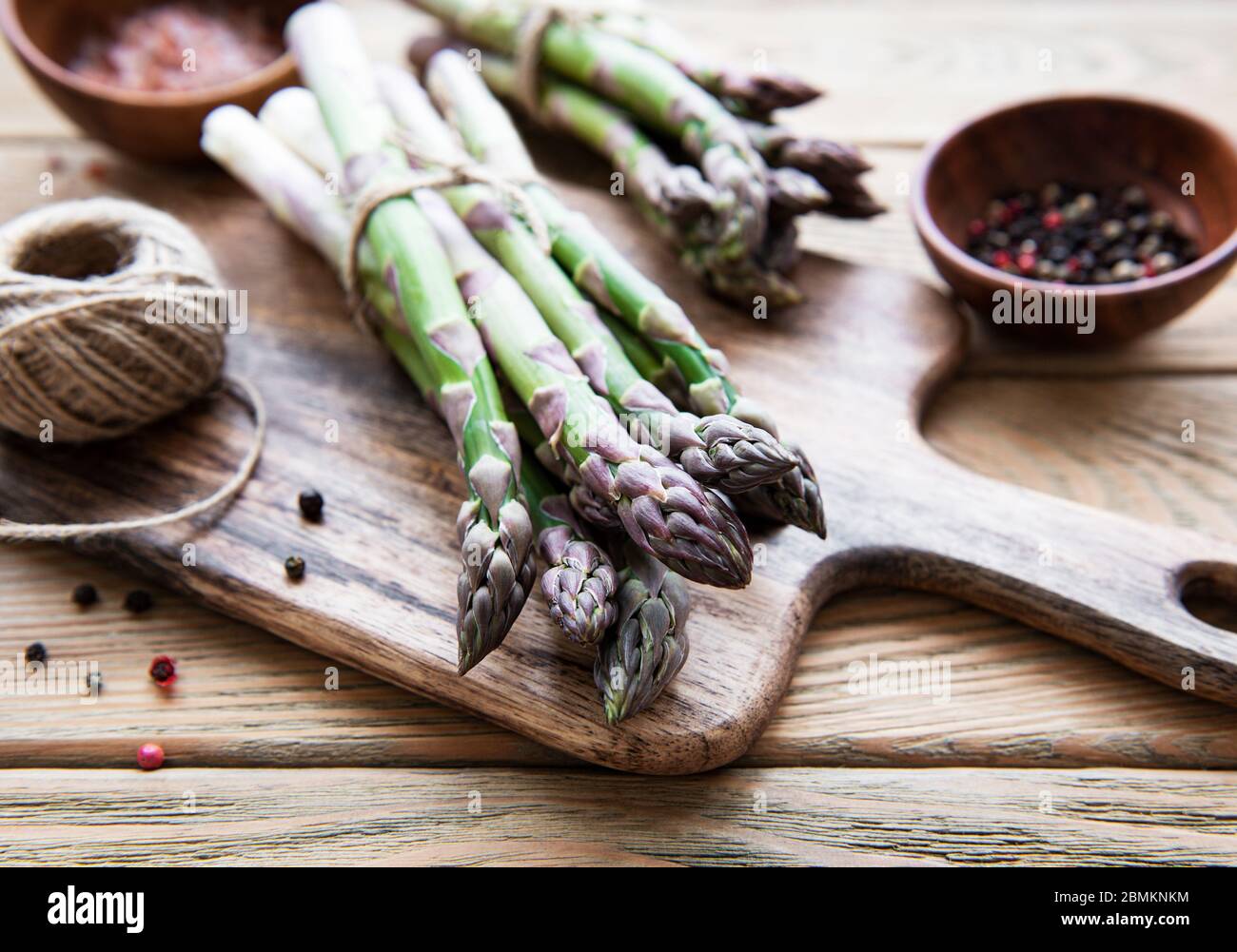 Bundle of fresh green asparagus on a rustic wooden table , top view ...