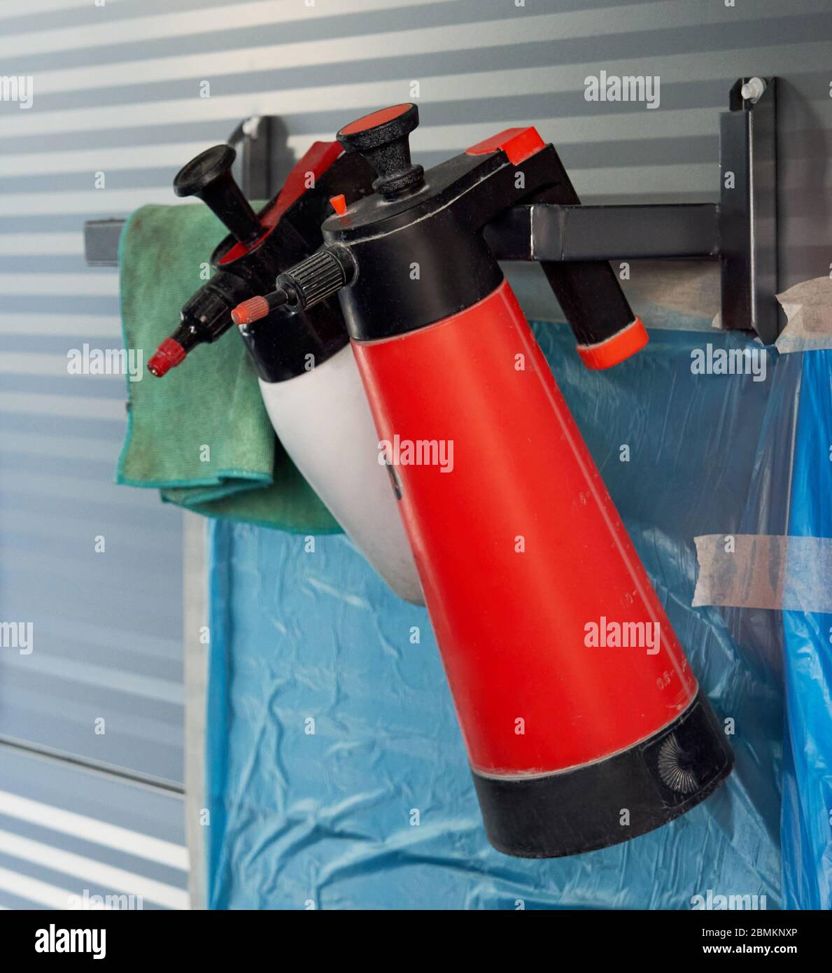 Plastic bottles with car spray hanging on the wall in auto repair shop ...