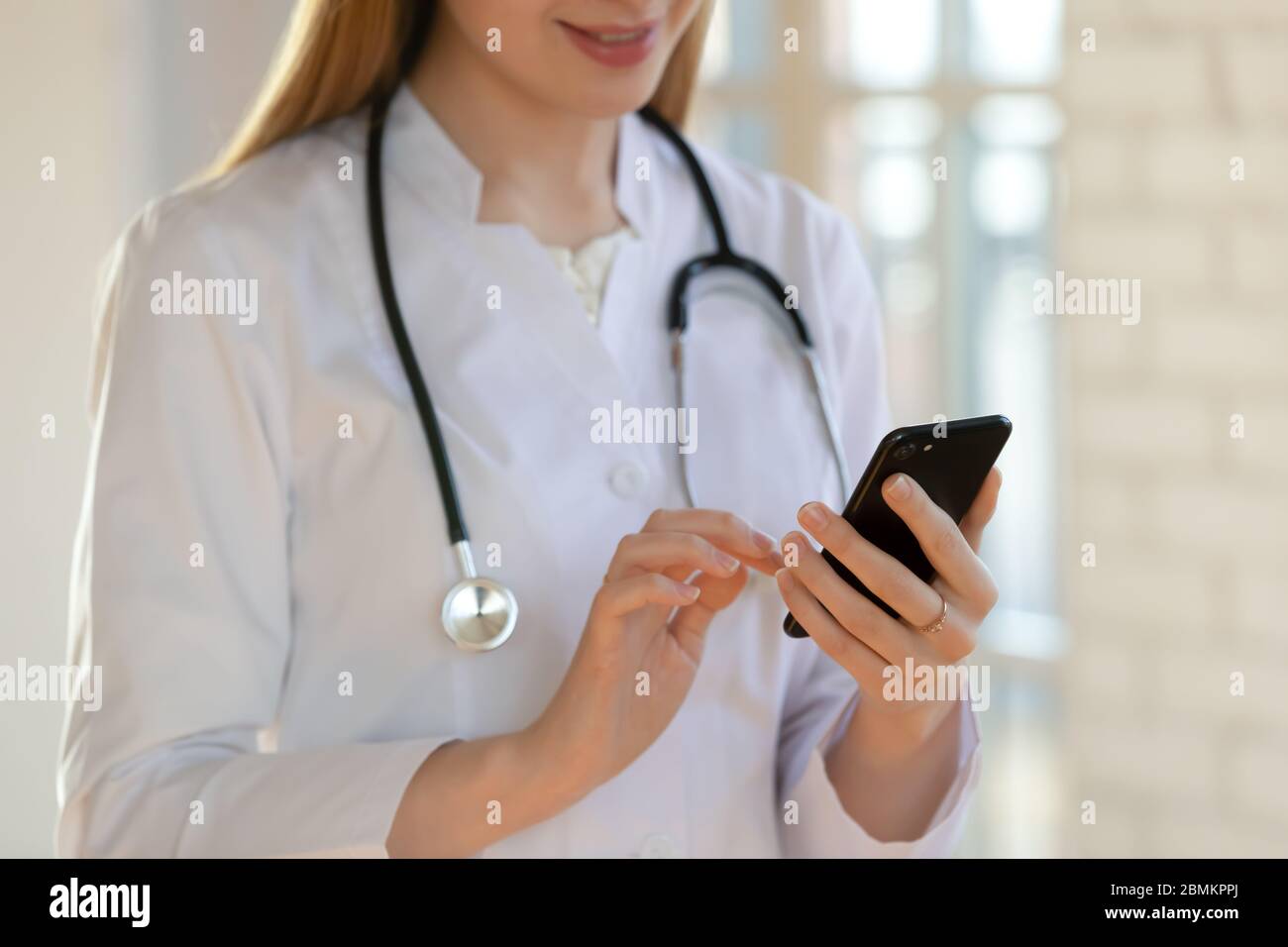 Female doctor browsing smartphone on hi-res stock photography and ...