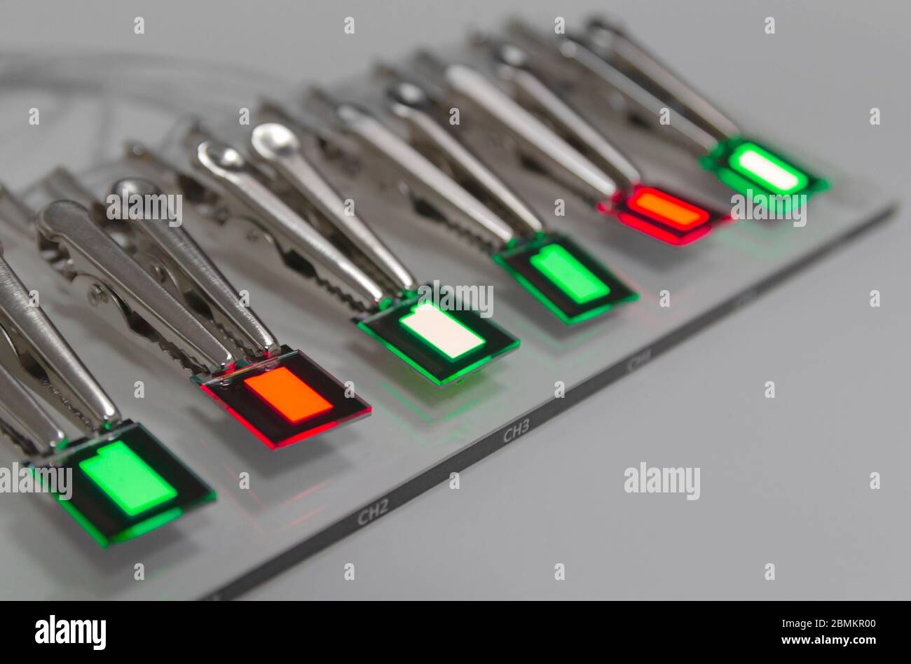 Several Red Green color oled displays is lighting on a probecard. Grey ...