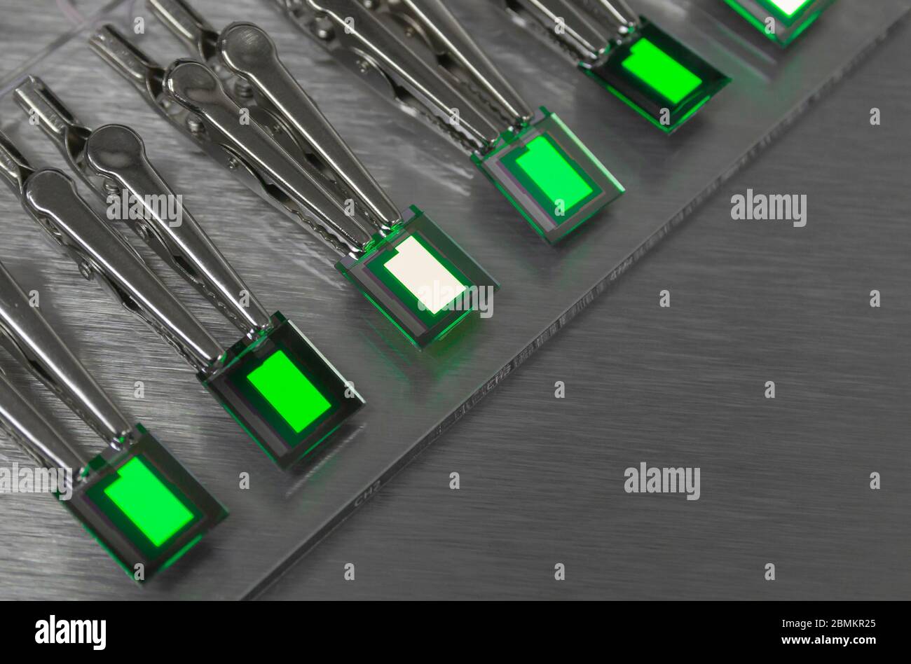 Several Green color oled displays is lighting on a probecard. Steel ...