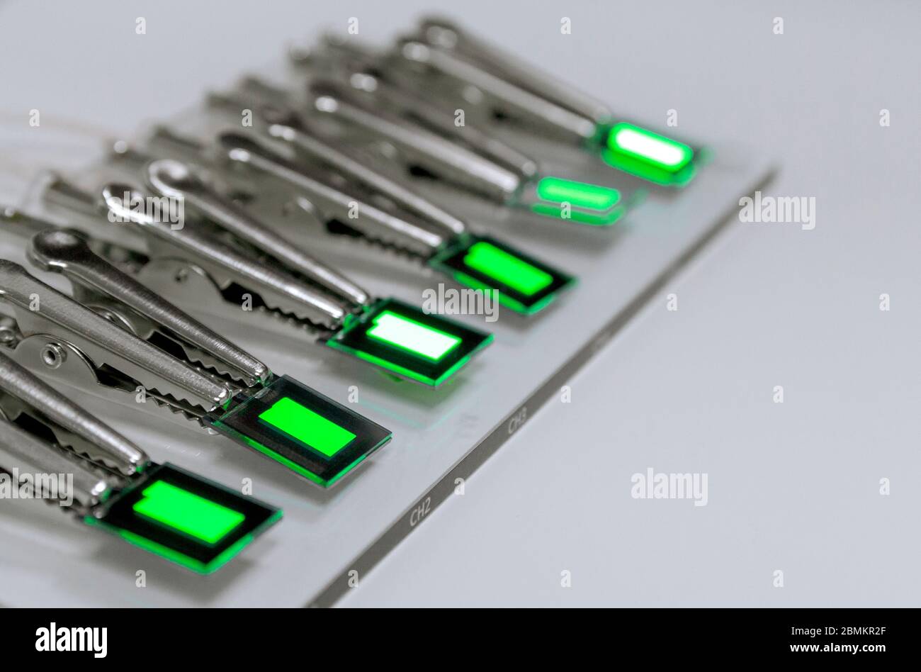 Several Green color oled displays is lighting on a probecard. Grey ...