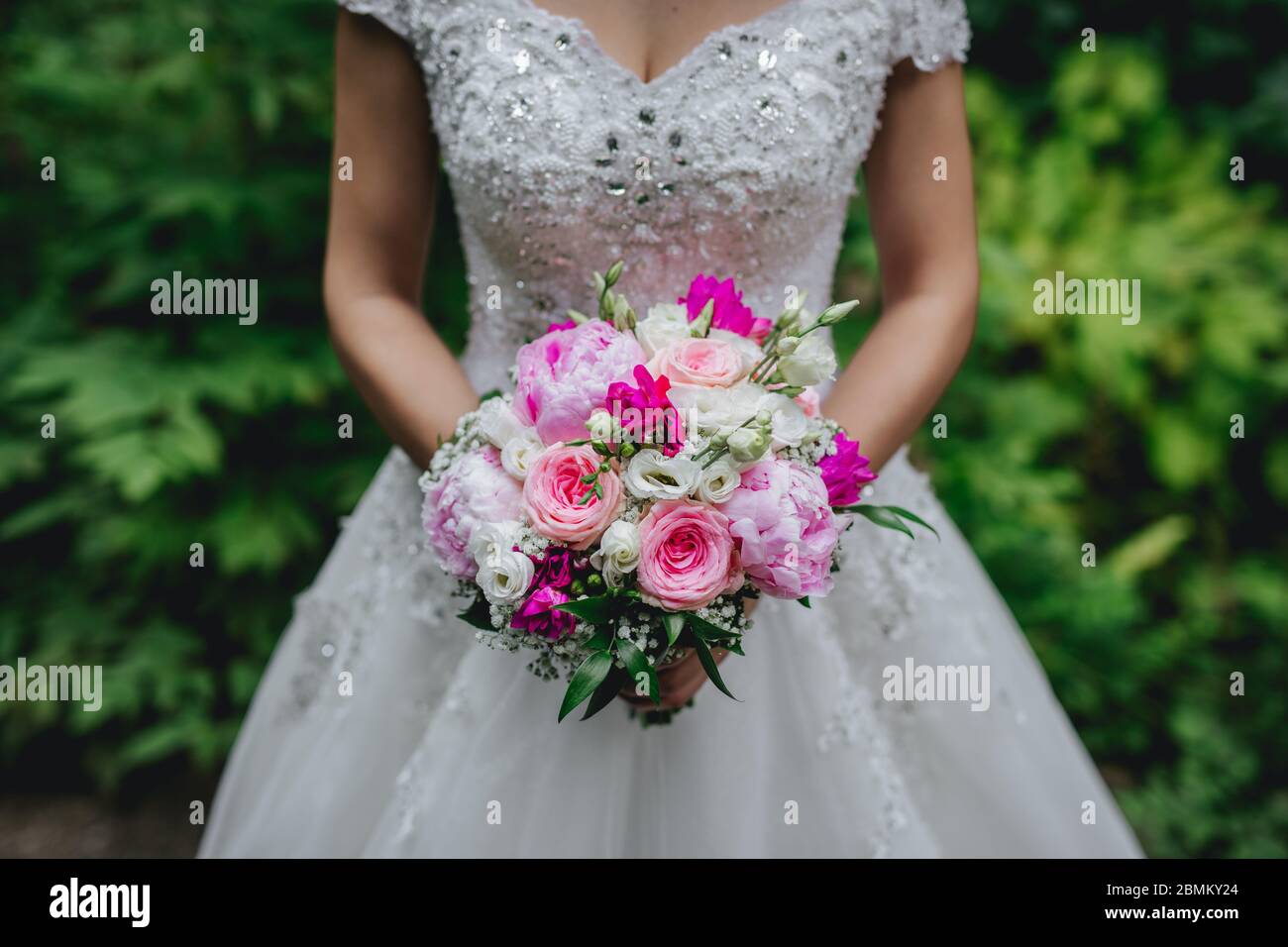 Bride holding flower bouquet close up Stock Photo - Alamy