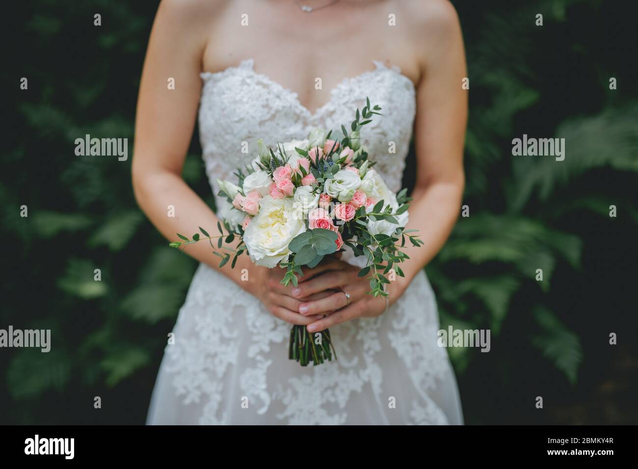 Bride holding flower bouquet close up Stock Photo - Alamy