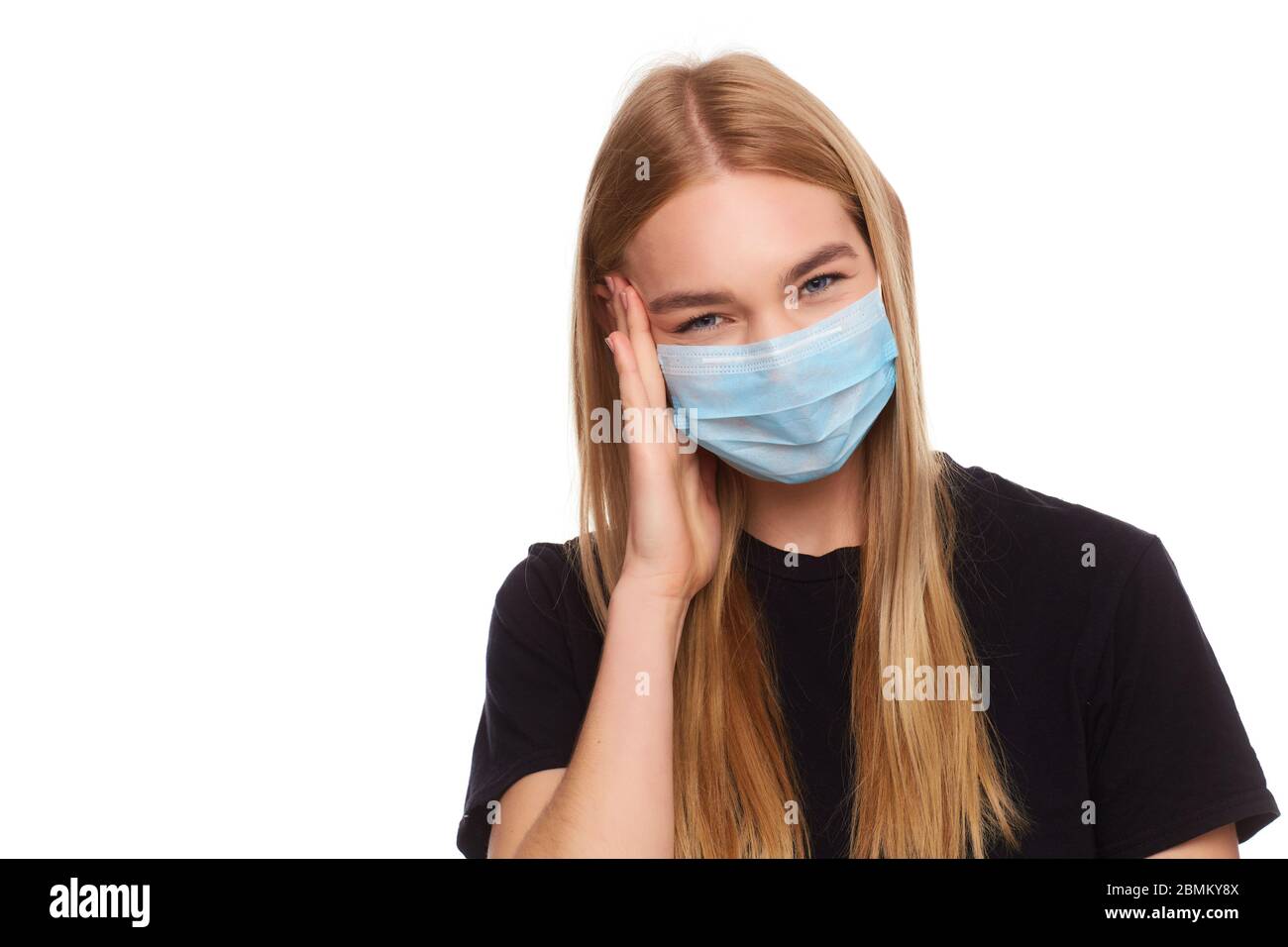 Studio portrait of young blonde illness girl with closed eyes, wearing ...