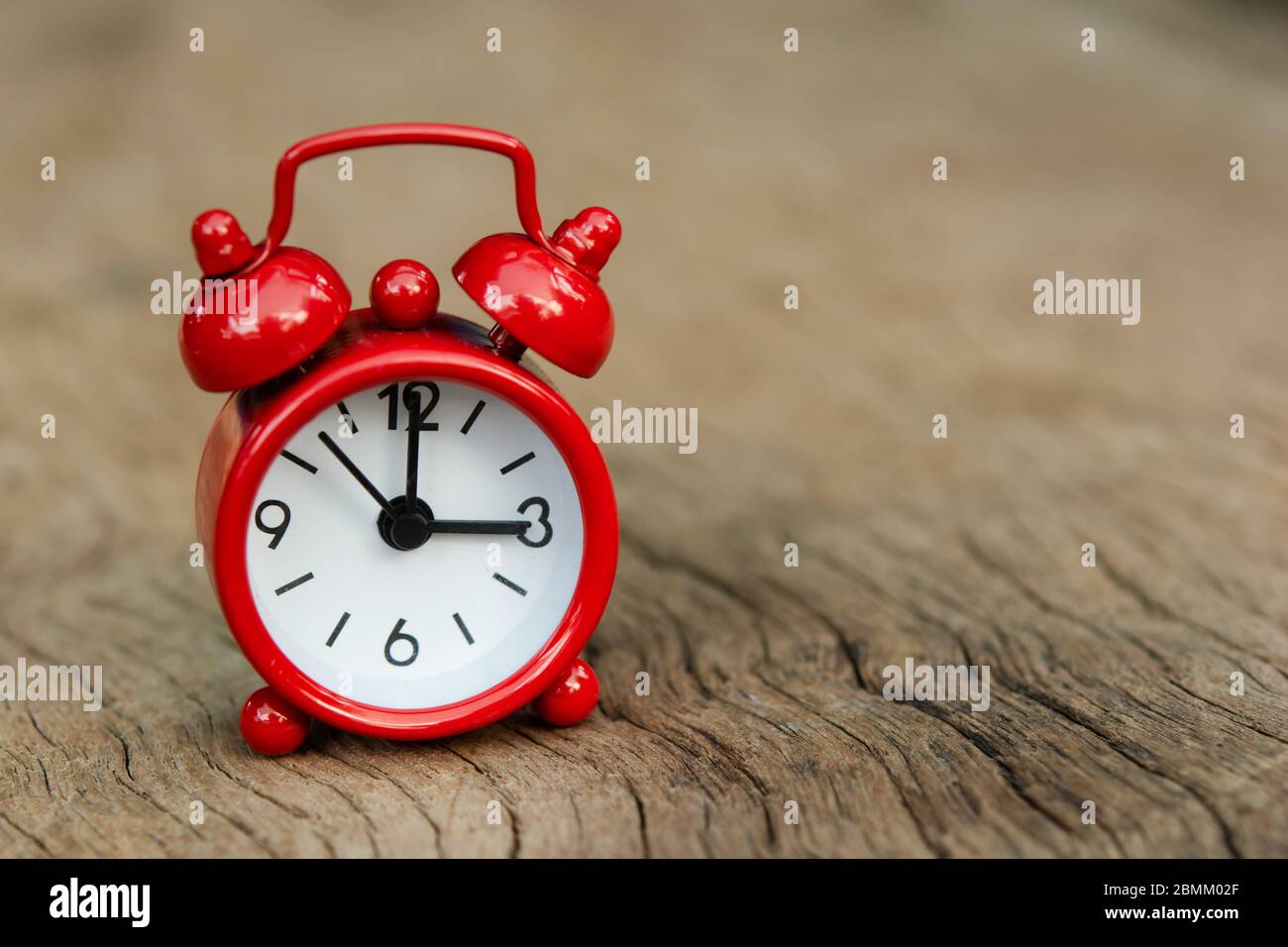 Red alarm clock on wood background with copy space Stock Photo - Alamy