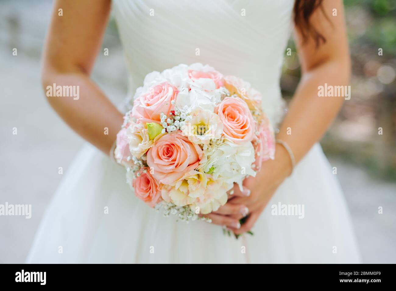 Bride holding flower bouquet close up Stock Photo - Alamy