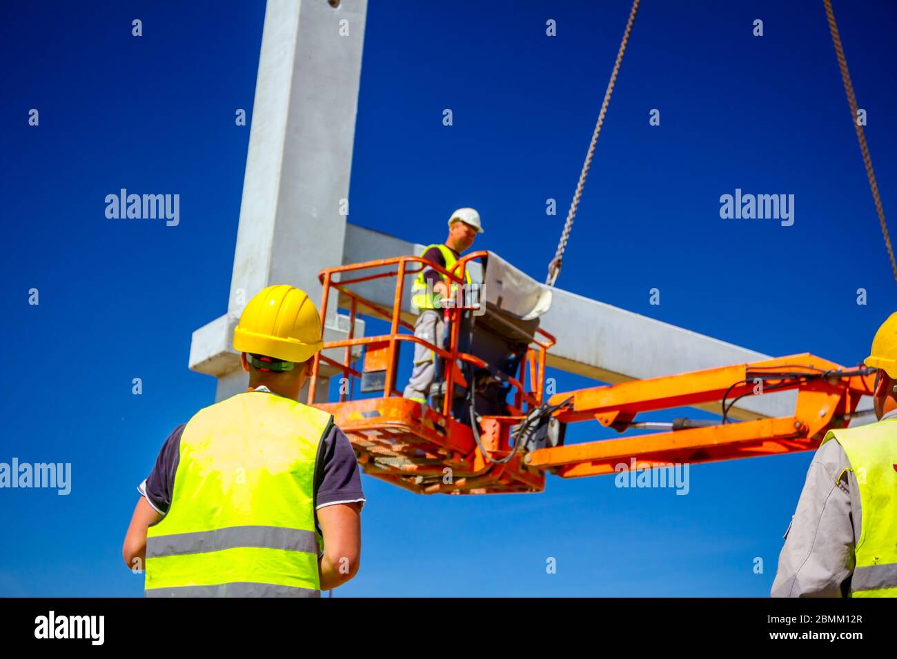 View from behind on construction worker with safety vest and yellow ...
