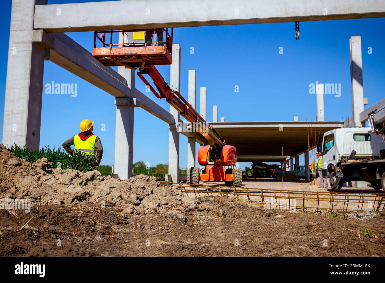 View from behind on construction worker with safety vest and yellow ...
