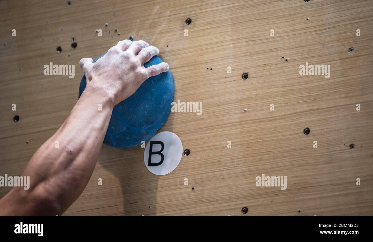Man bouldering and climbing indoor Stock Photo - Alamy