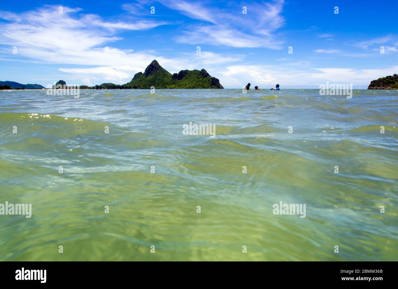 Wide view at the water surface level of movement sea and the island ...