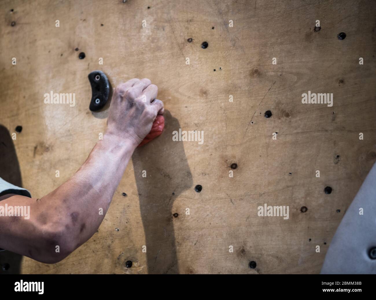 Man bouldering and climbing indoor Stock Photo - Alamy