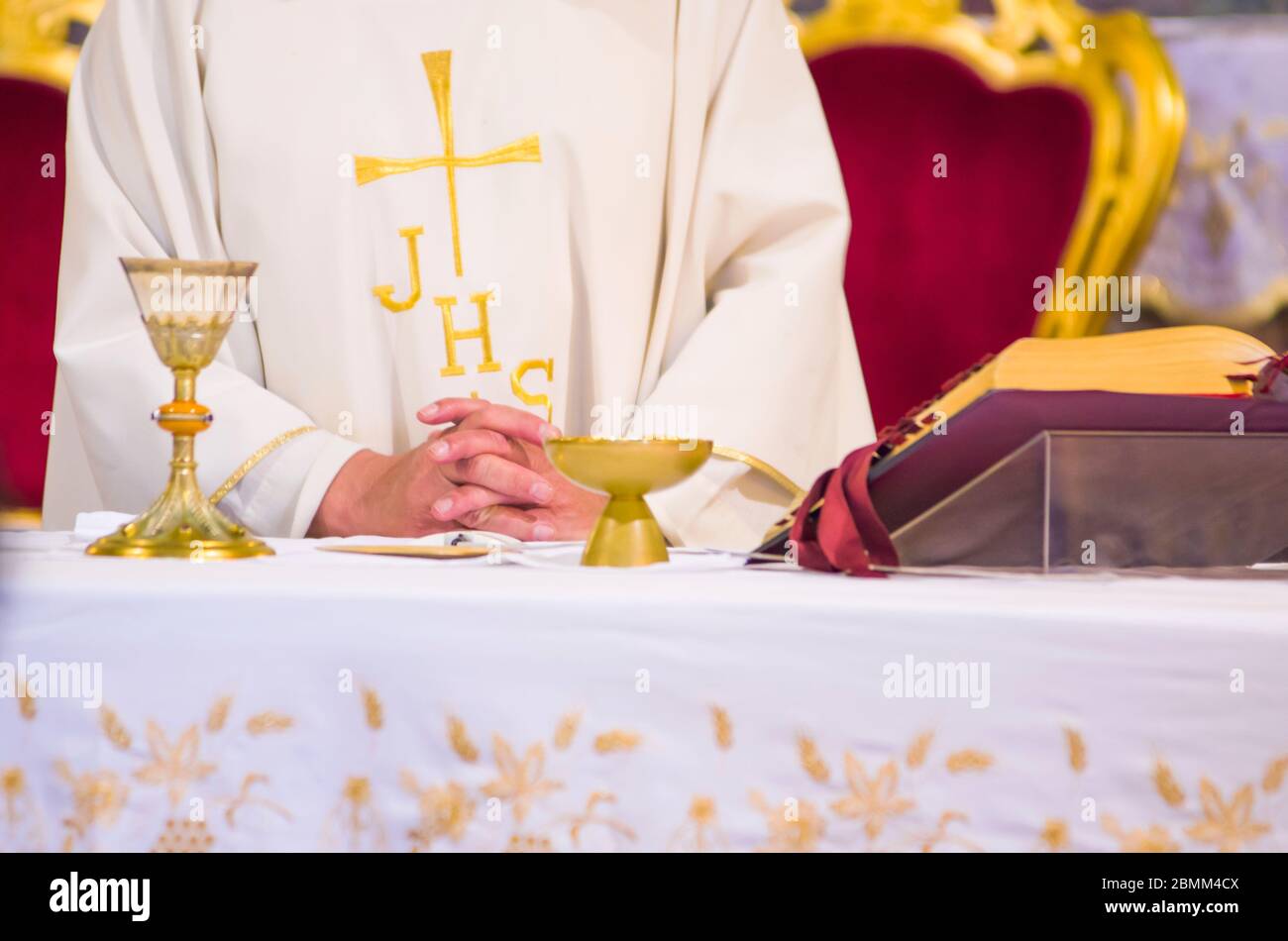 altar with host that becomes the body of jesus christ and chalice for ...