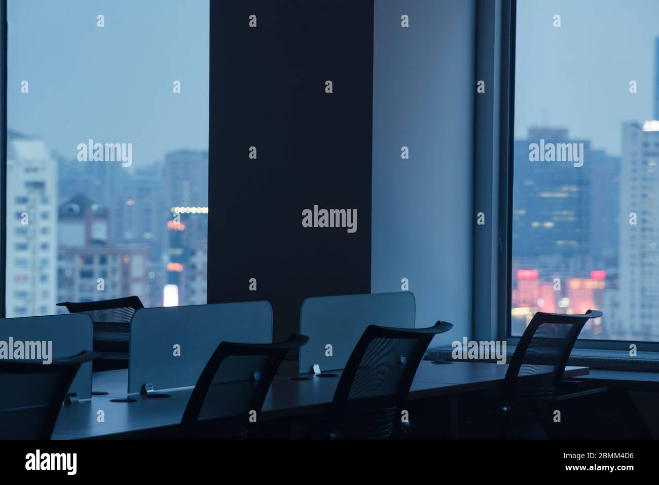 Working late. Office windows by night Stock Photo - Alamy