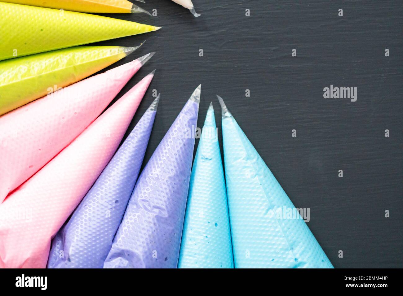 Variety of colors of royal icing in plastic piping bags Stock Photo - Alamy