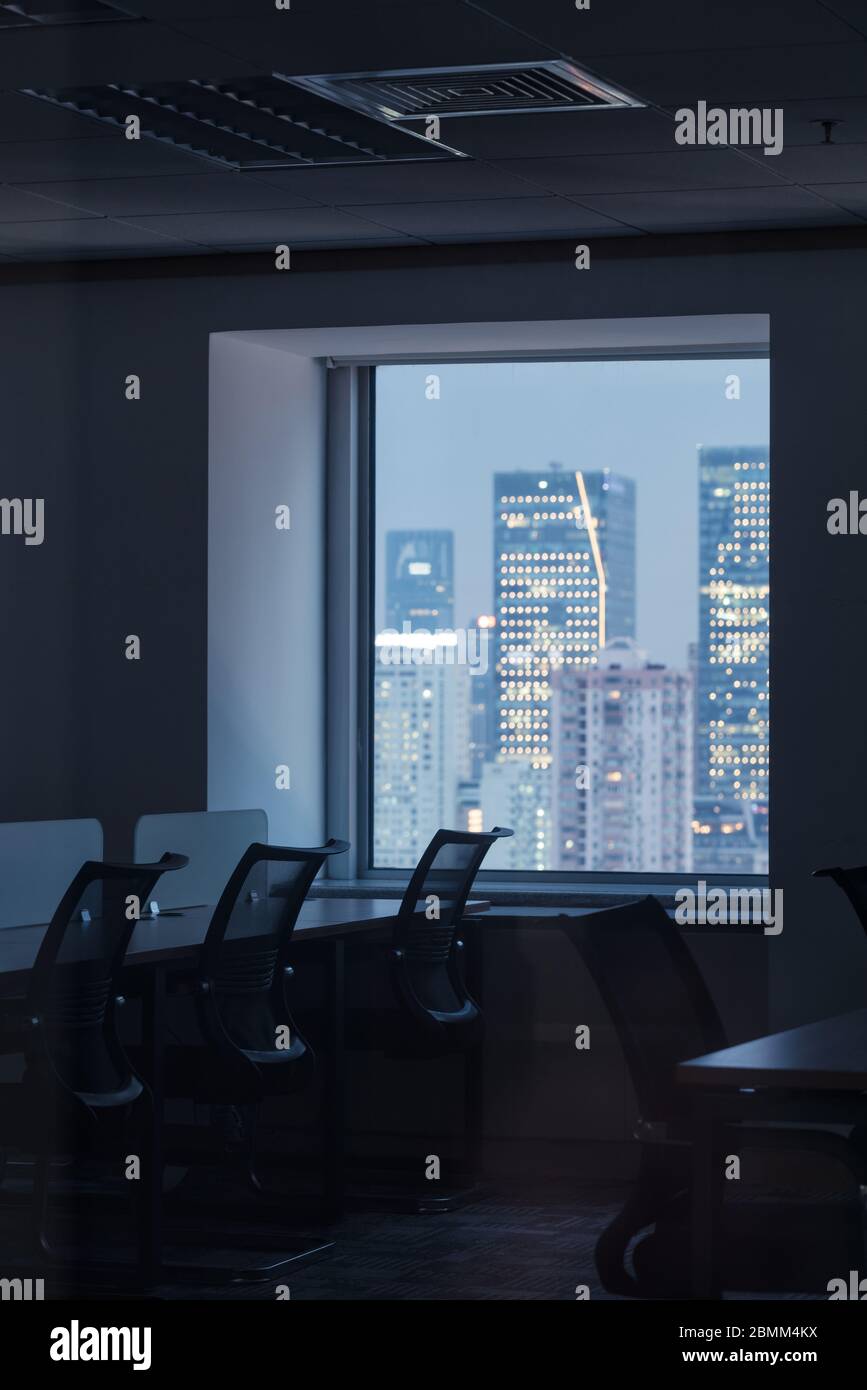 Working late. Office windows by night Stock Photo - Alamy