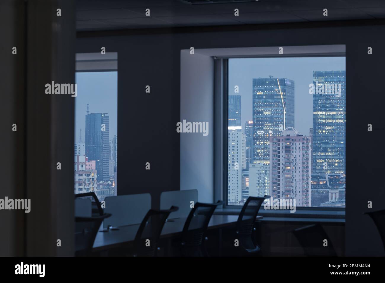 Working late. Office windows by night Stock Photo - Alamy