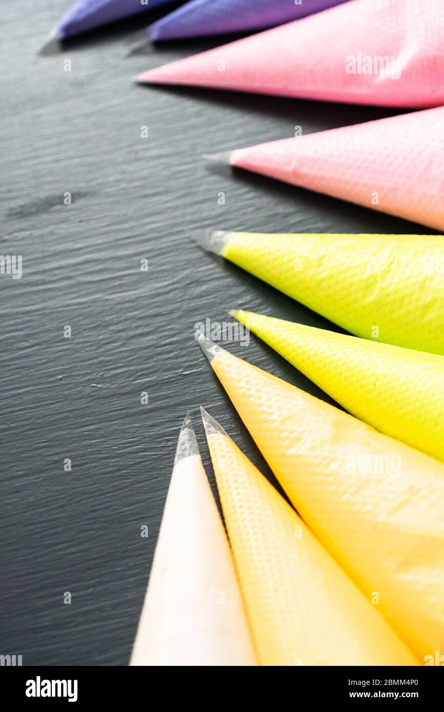 Variety of colors of royal icing in plastic piping bags Stock Photo - Alamy