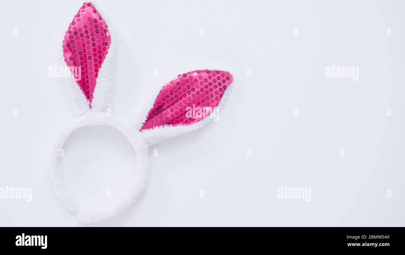 White and pink Easter bunny ears on a white background Stock Photo - Alamy