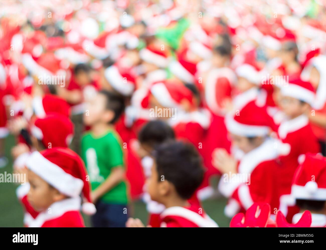Students in red theme costume in Christmas party of elementary school ...