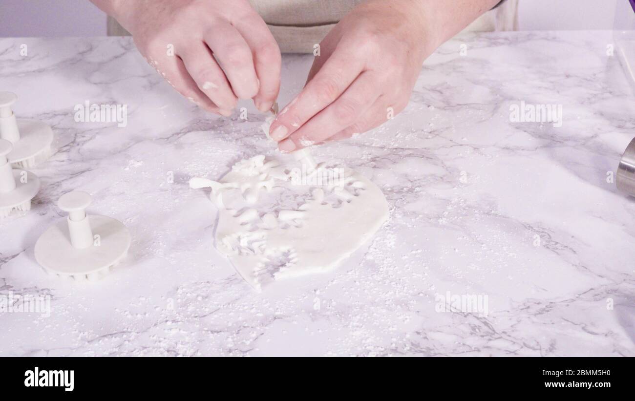 Step by step. Cutting out snowflakes with cookie cutters out of white ...