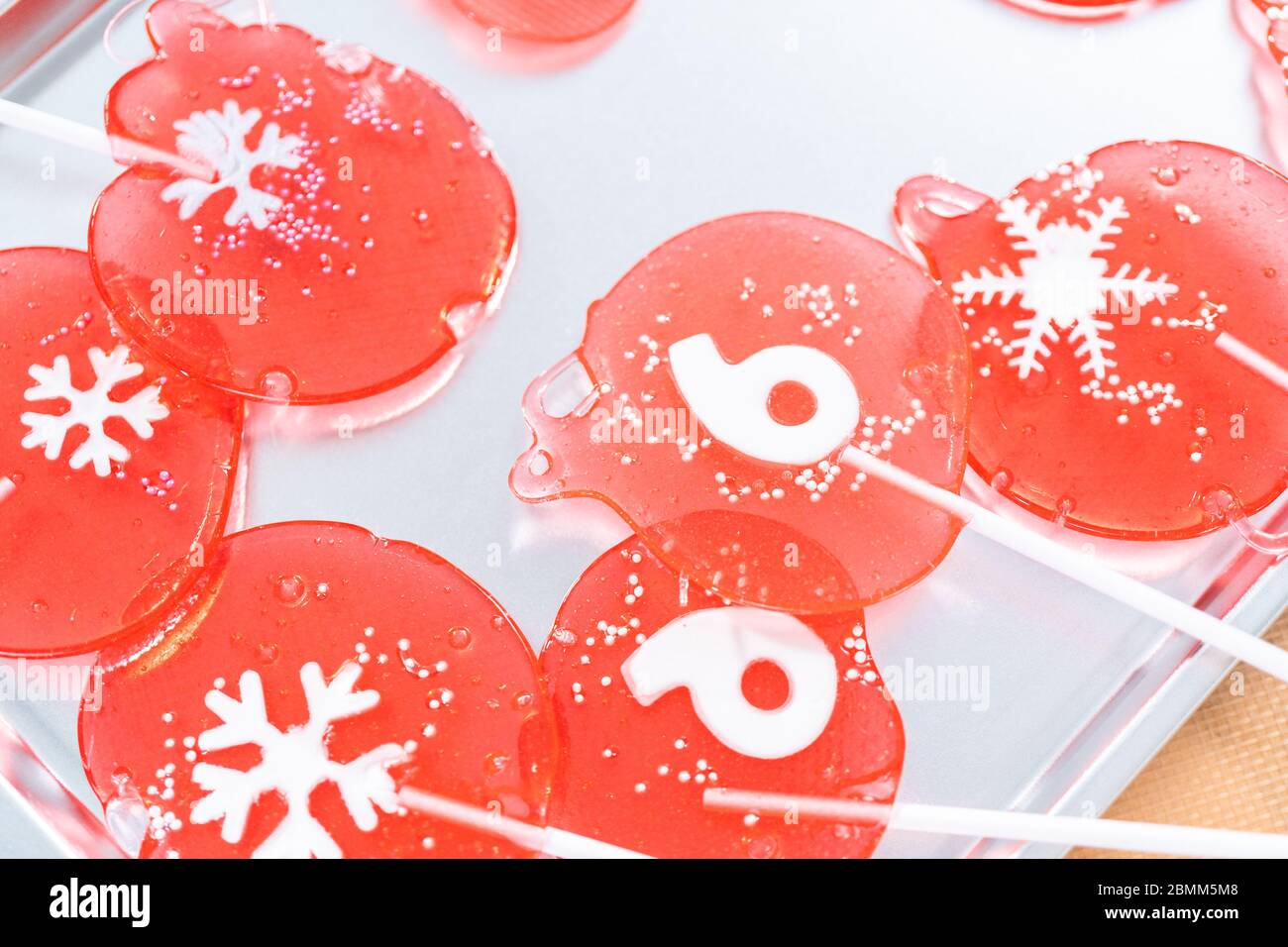 Homemade berry flavor lollipops with snowflakes on a white lollipop ...