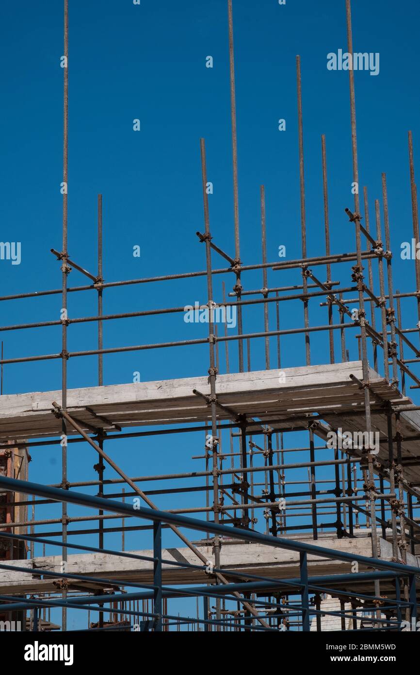 scaffolding building construction site against blue sky Stock Photo - Alamy