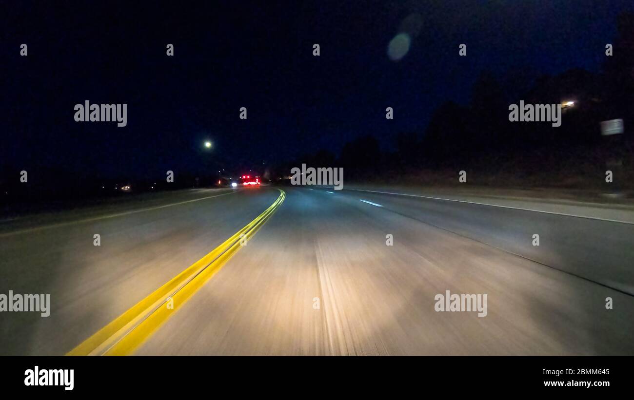 Driving on typical paved roads at night in suburban America Stock Photo ...