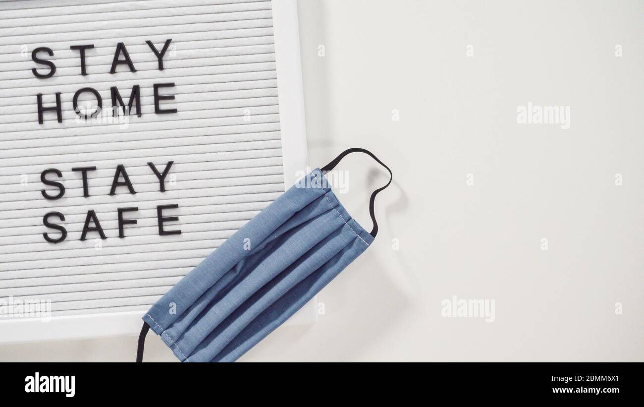 Flat lay. STAY HOME and STAY SAFE sign on message board with a homemade ...