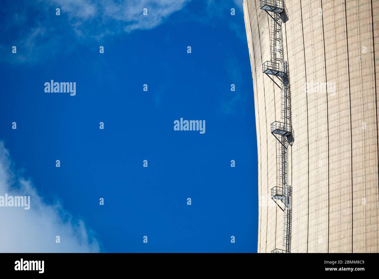 A cooling tower with ladders and blue sky Stock Photo - Alamy