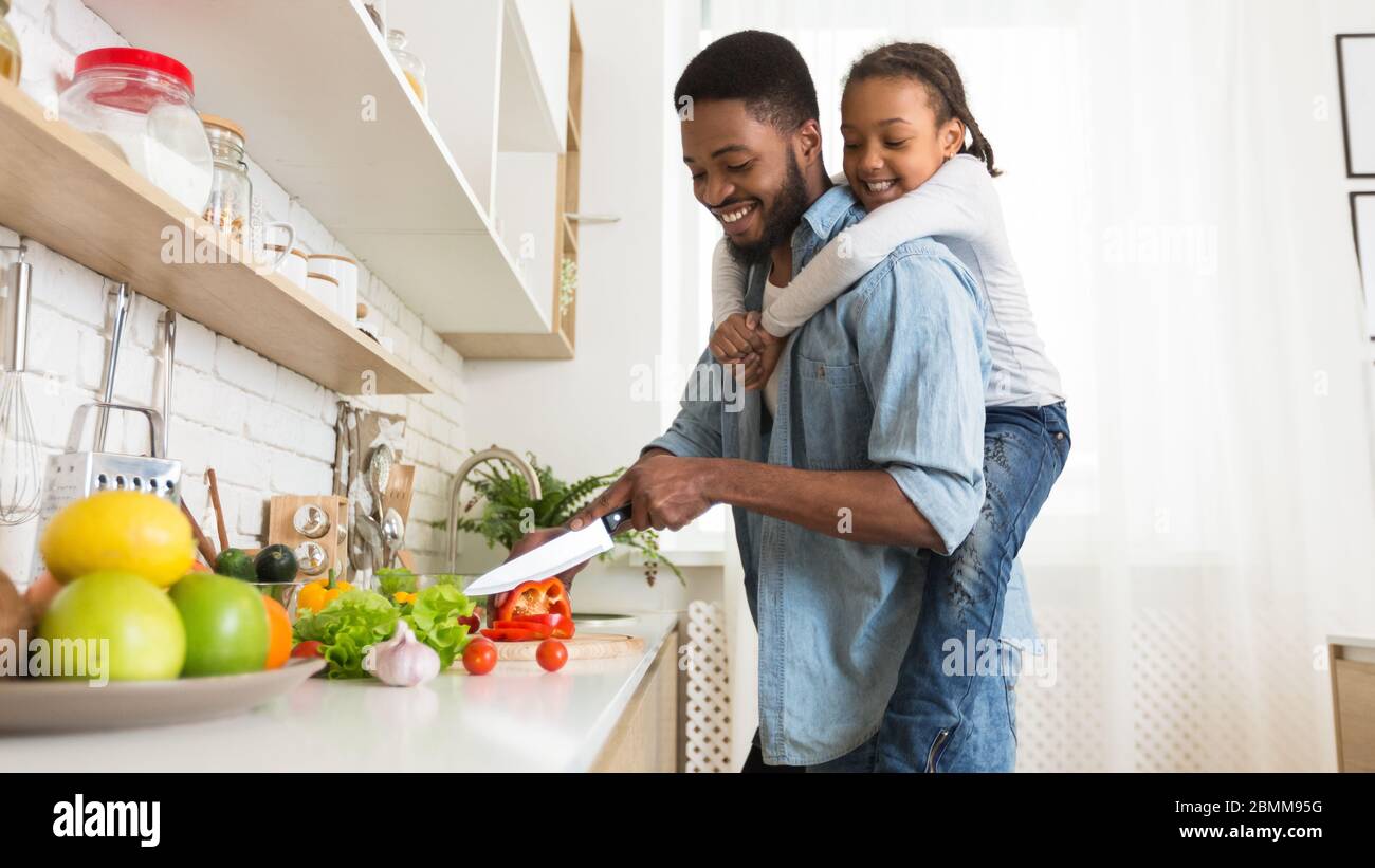Daddy and daughter having fun while cooking at kitchen Stock Photo - Alamy