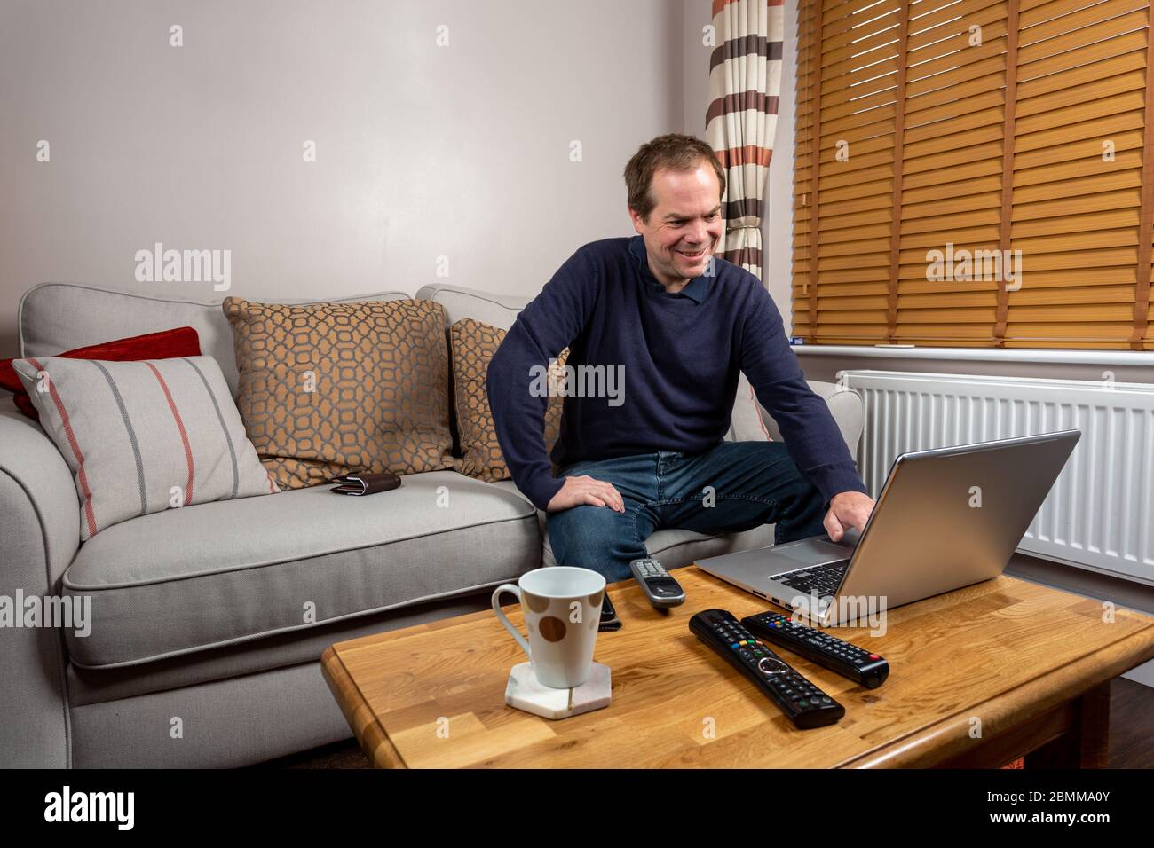 Working from home at a coffee table office Stock Photo - Alamy