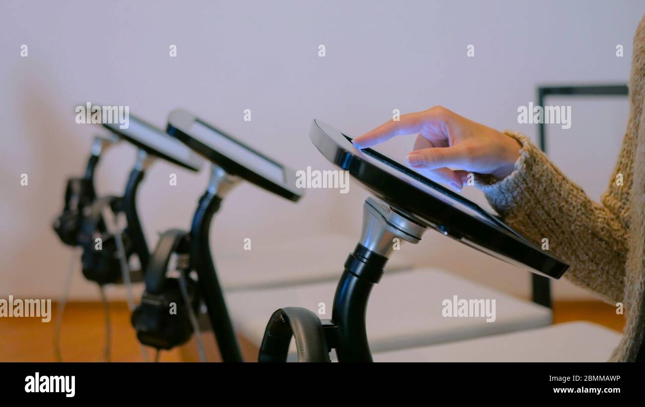 Woman using interactive touchscreen display tablet at jewish modern ...