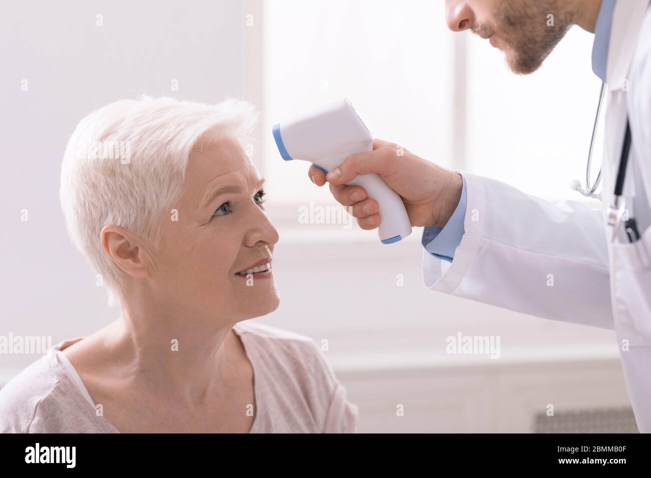 Fevers measure forehead by infrared for patient in clinic Stock Photo ...