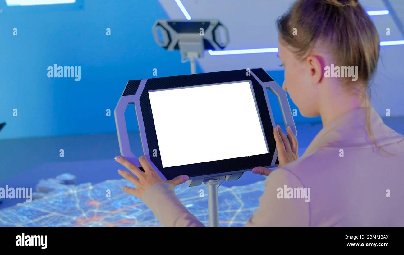 Woman using interactive empty white touchscreen display at modern ...