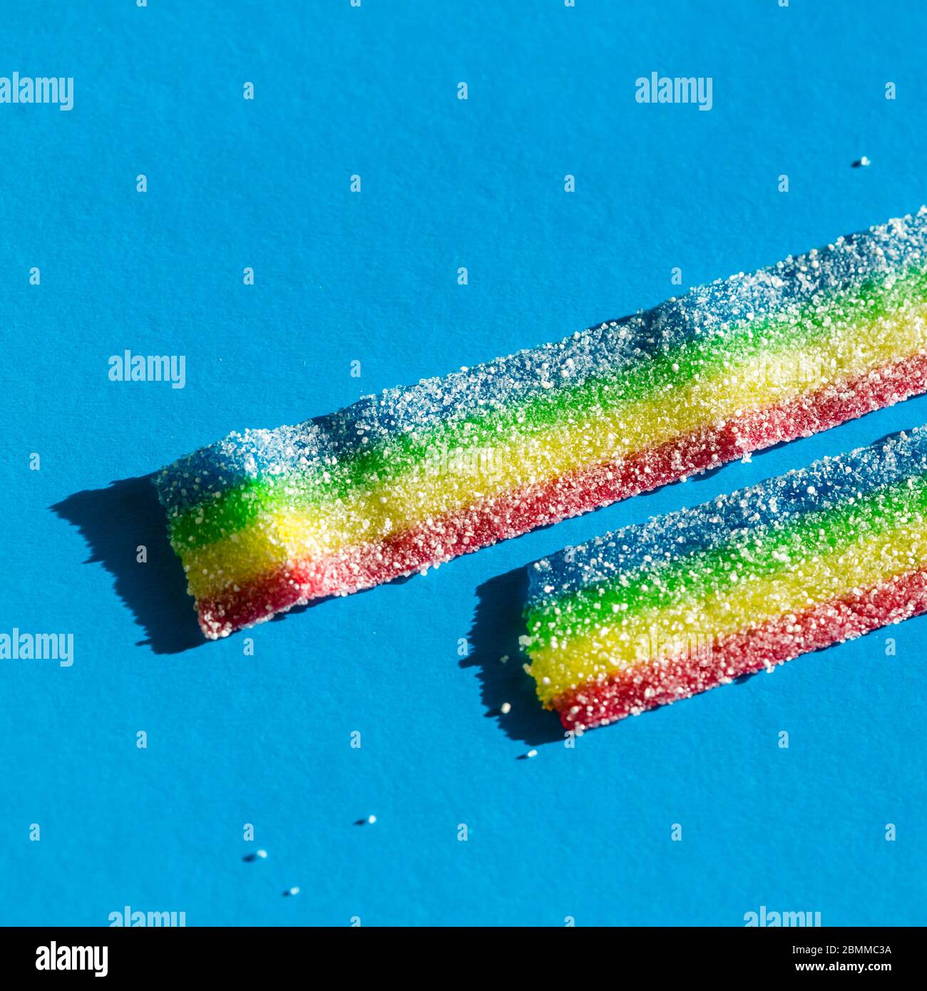 Natural rainbow colored marmalade candy on the blue background. Copy ...