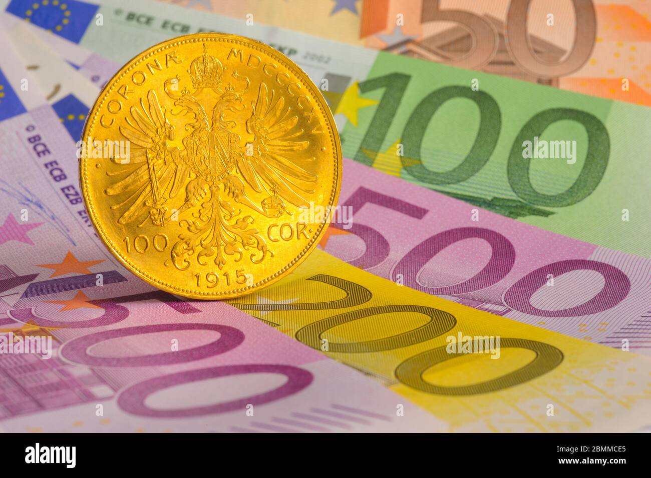 gold coin and euro banknotes Stock Photo - Alamy