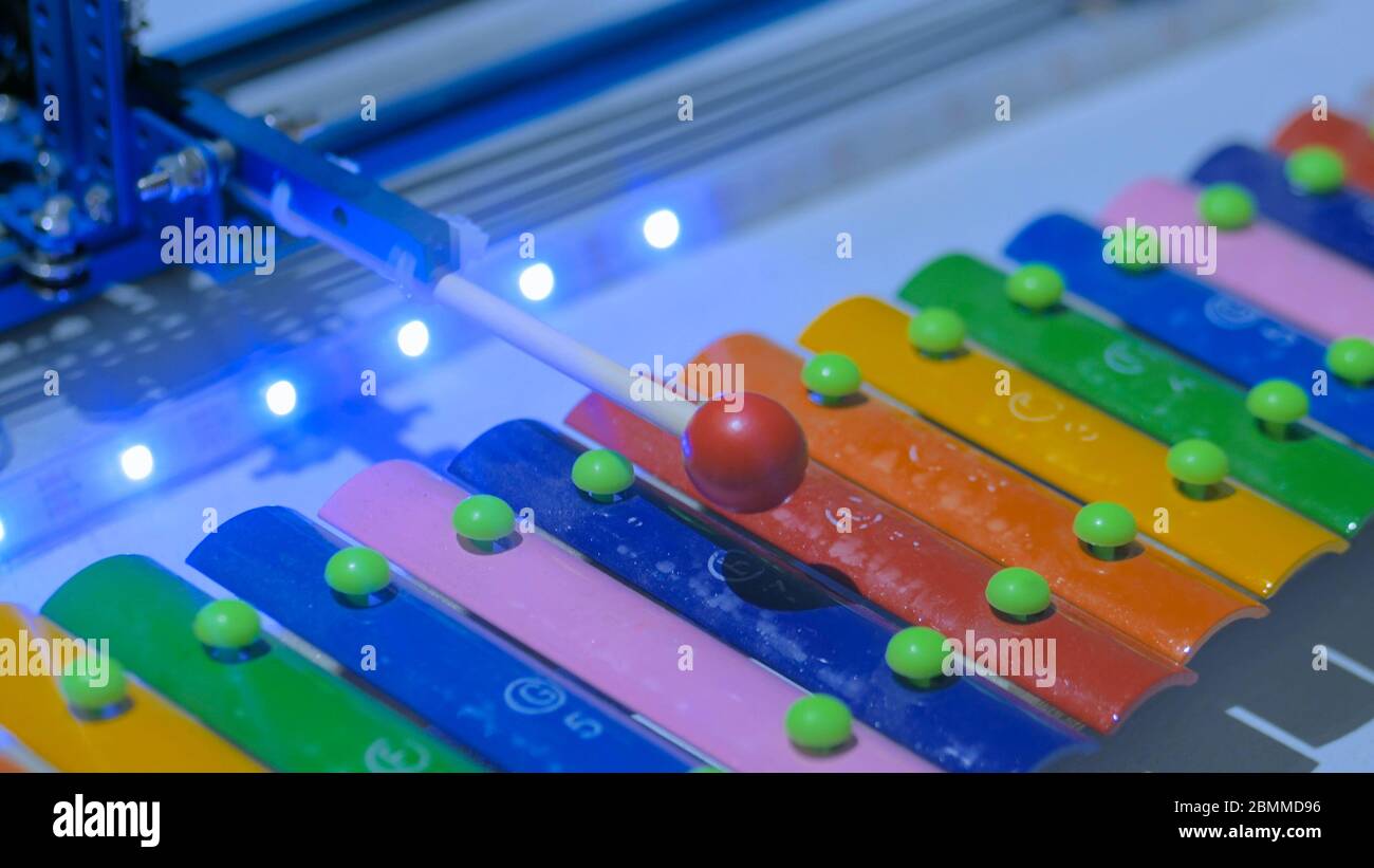 Robot playing on colorful xylophone at technology exhibition. Future ...