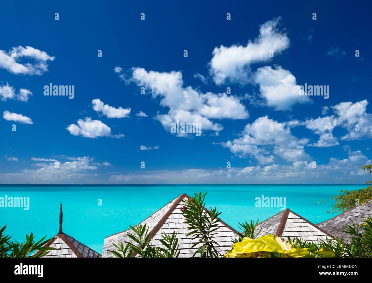 View over some roofs to the deep turquoise Caribbean Sea under a blue ...