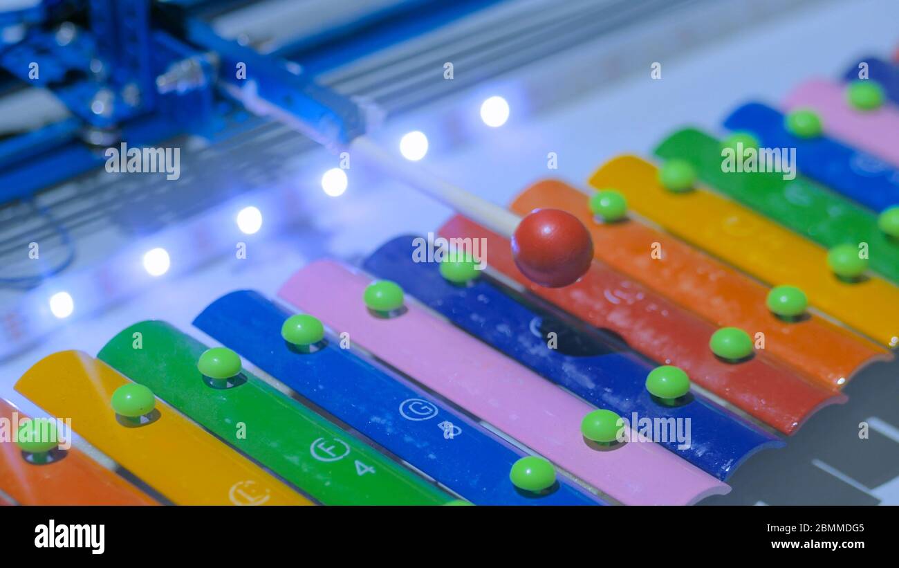 Robot playing on colorful xylophone at technology exhibition. Future ...