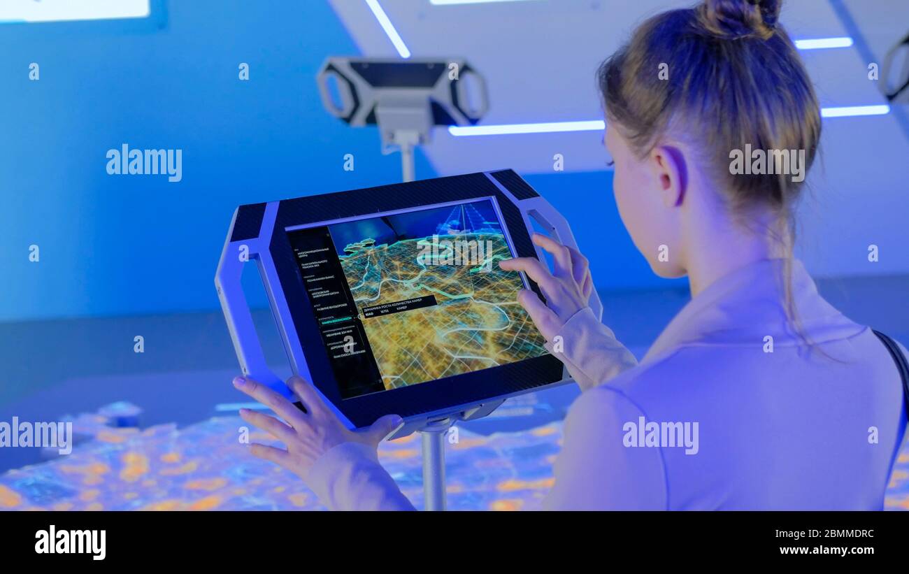 MOSCOW, RUSSIA - July 30, 2018: Smart City Exhibition. Woman using ...