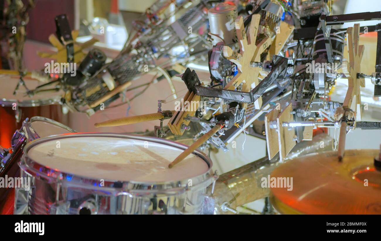 Vintage robot playing drums. Closeup shot of robot hand with drumstick ...