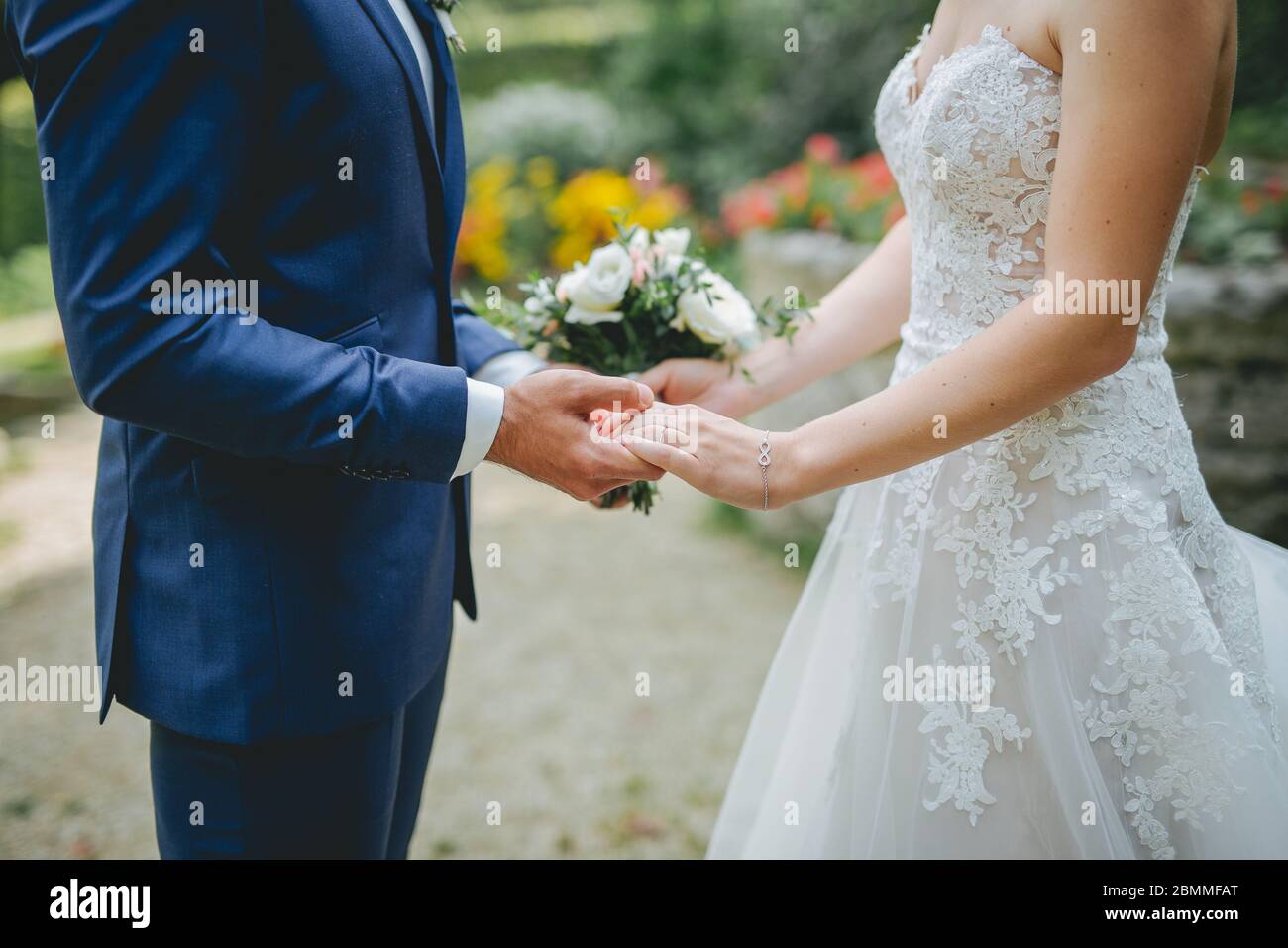 Bride and groom holding hands Stock Photo - Alamy