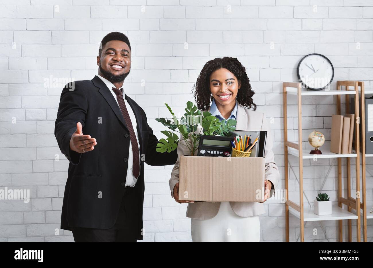 New job concept. Happy African American boss welcoming employee on her ...